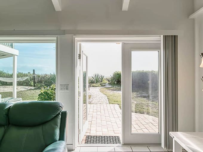 Glass doors frame the view to your backyard oasis, making the transition from indoor comfort to outdoor paradise absolutely seamless.