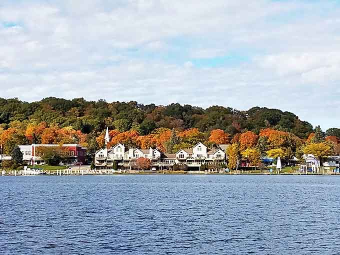Waterfront homes nestle against autumn's fiery palette, creating a scene so perfect it could be Michigan's answer to a Norman Rockwell painting.