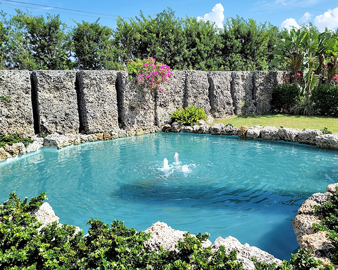 The crystal-clear reflecting pool offers a moment of serenity amidst the imposing stone structures.