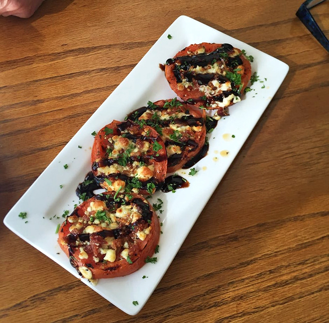 Grilled Tomato: Simple ingredients transformed&mdash;these tomatoes have been kissed by fire and dressed with herbs, cheese, and balsamic reduction.