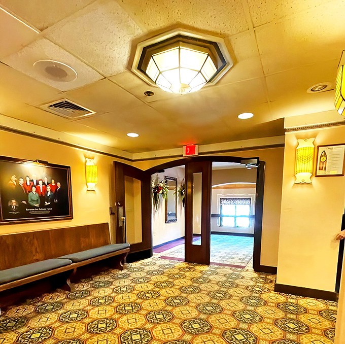 Intricate patterns dance across the carpet while elegant chandeliers cast a warm glow over diners enjoying their German feast.