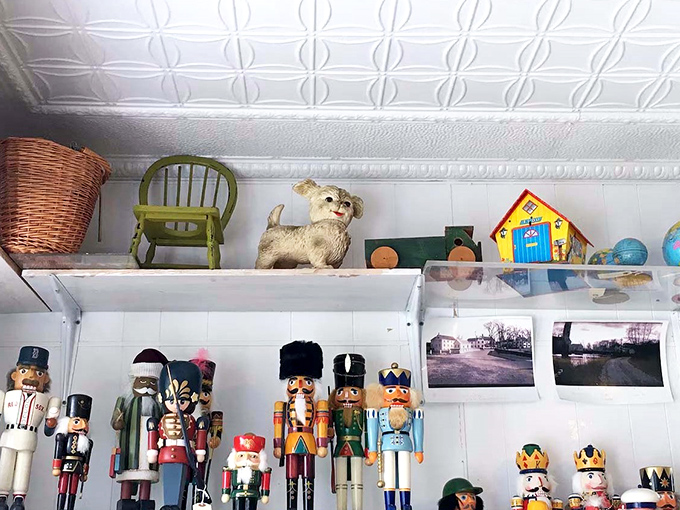 A whimsical collection of nutcrackers stands guard over maritime memories, adding unexpected charm to the nautical decor.