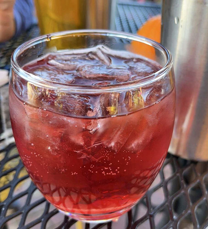 This ruby-red pomegranate beverage sparkles like liquid jewels, offering the perfect balance of sweet and tart refreshment between bites of savory dishes.