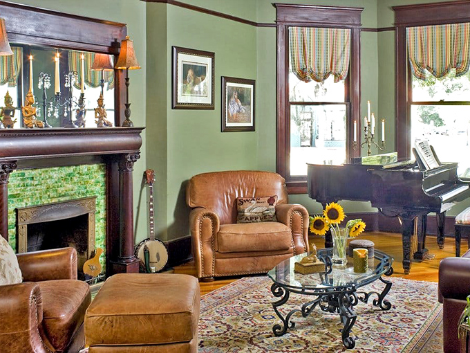 Leather chairs, a gleaming piano, and a distinctive green fireplace create the perfect setting for evening conversations.