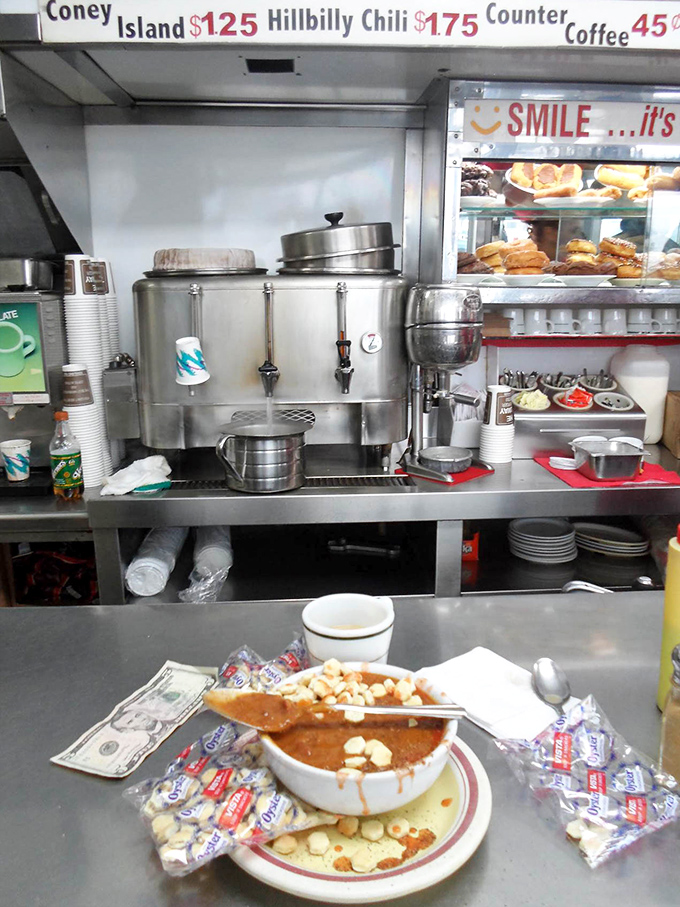 Behind the counter, culinary magic happens with practiced efficiency. The "SMILE" sign isn't just decoration &ndash; it's the Telway philosophy in action.