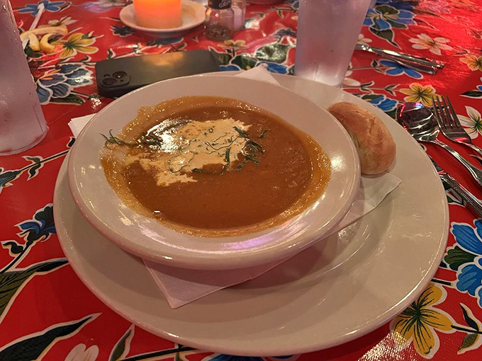 A bowl of shrimp and lobster bisque that's basically a warm hug in liquid form, complete with a bread sidekick for dunking.