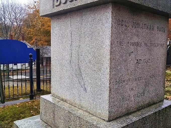The side of the monument reveals additional historical information about Buck, though visitors are inevitably drawn to the leg-shaped stain.