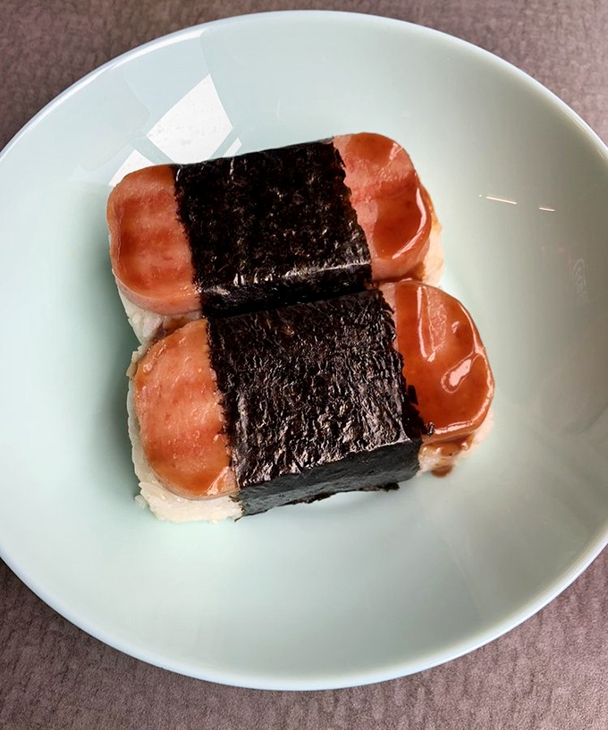 Spam musubi &ndash; Hawaii's beloved snack wraps grilled Spam and rice in nori, creating a handheld delight that's greater than the sum of its parts.