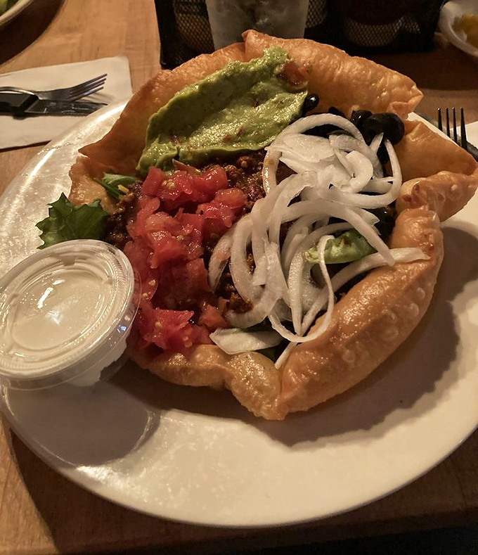 An edible bowl cradles layers of Tex-Mex goodness &ndash; technically a salad, spiritually a fiesta on a plate.