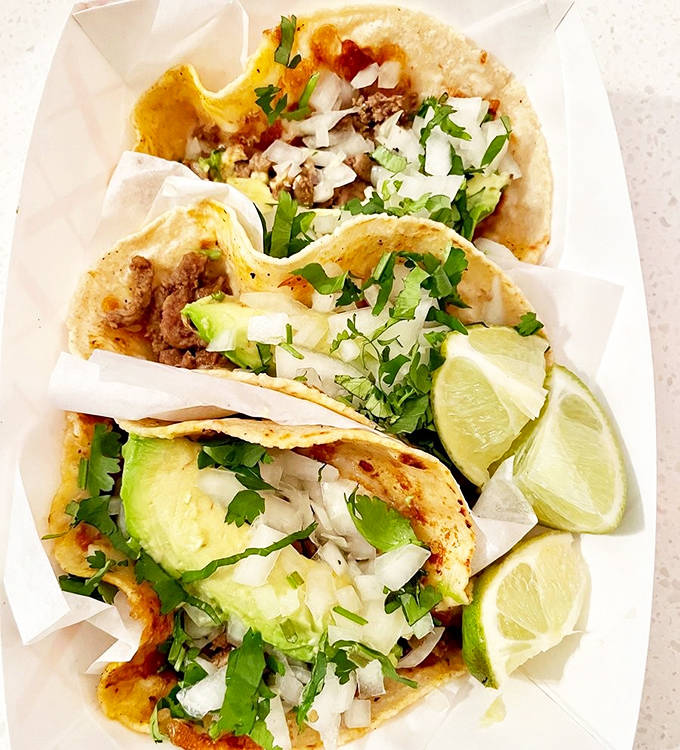 Tacos Pirata: These street tacos, adorned with fresh cilantro, onion, and lime, showcase the simple perfection that happens when quality ingredients meet traditional technique.