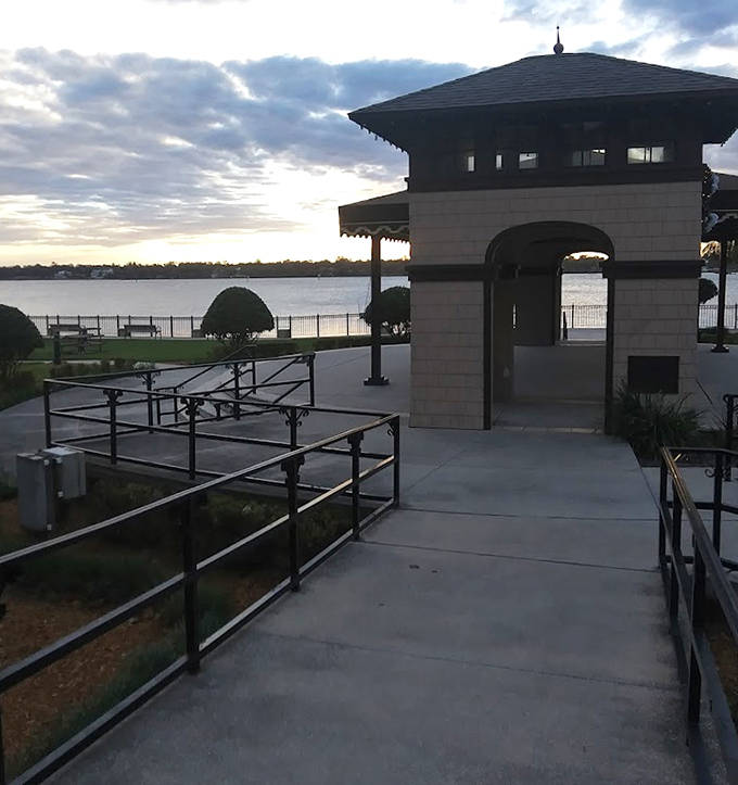 Sunset casts golden light across this waterfront pavilion, where locals gather to witness day's end in collective appreciation.