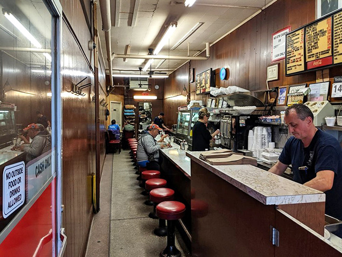 The heart of operations: a well-worn counter where countless elbows have rested while waiting for that perfect Coney dog.