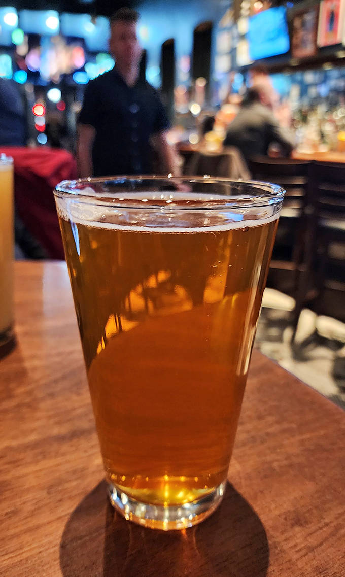 Amber liquid gold catching the bar light just right, promising refreshment that perfectly complements those legendary wings.