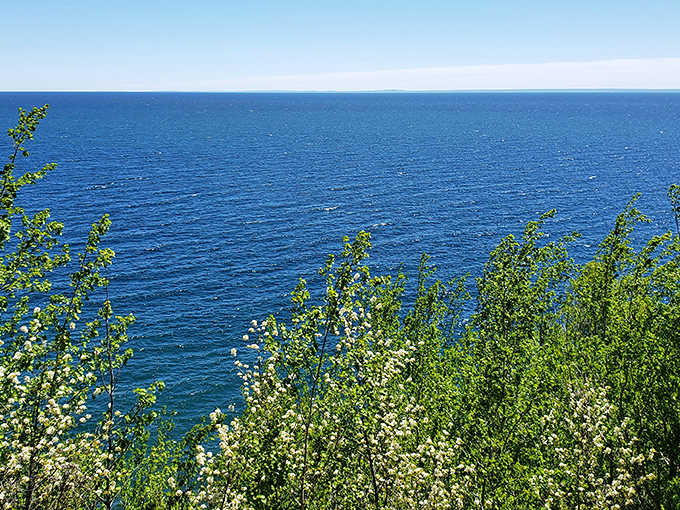 Lake Superior stretches to the horizon in impossible shades of blue, the same view that has captivated travelers along this route for generations.