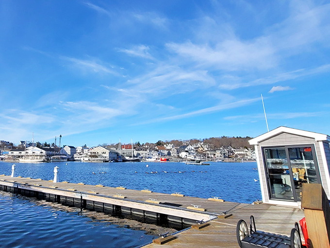 Morning light bathes the harbor docks in golden possibility, as boats await another day of maritime adventures on Boothbay's waters.