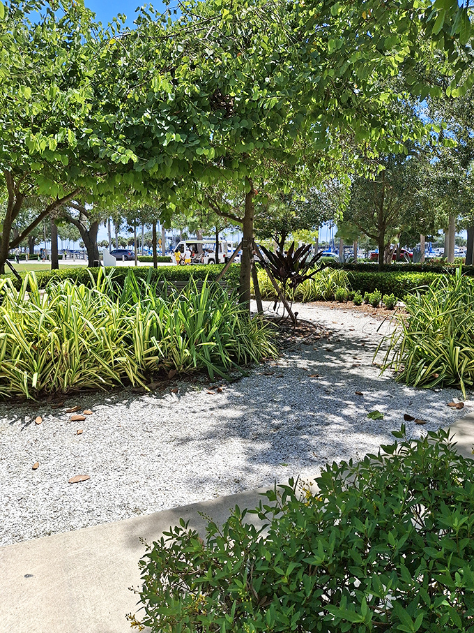 Winding pathways through meticulously maintained Florida vegetation offer peaceful moments between playground adventures.