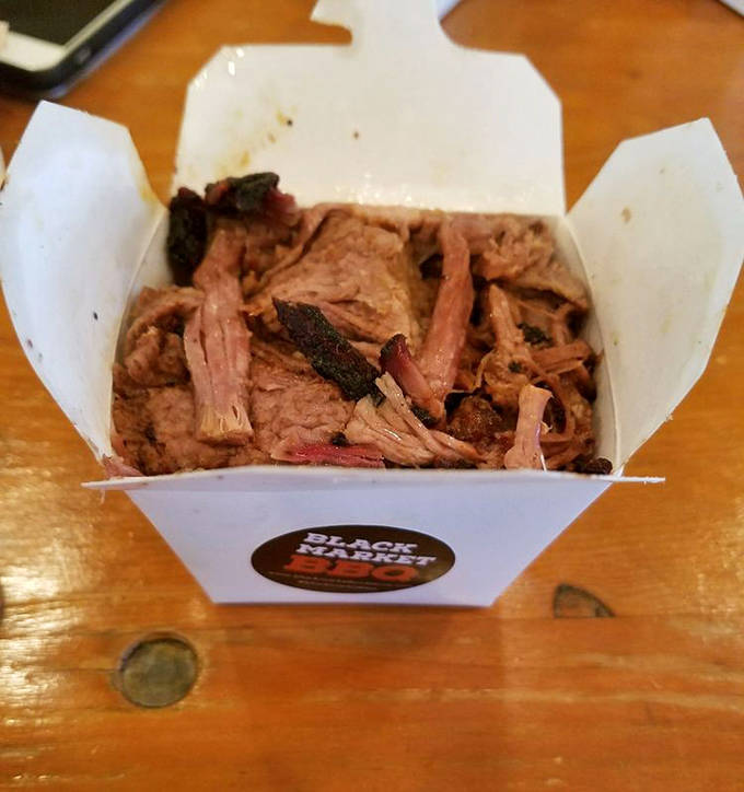 A humble takeout container holding barbecue treasures that will haunt your dreams and recalibrate your definition of "good food."