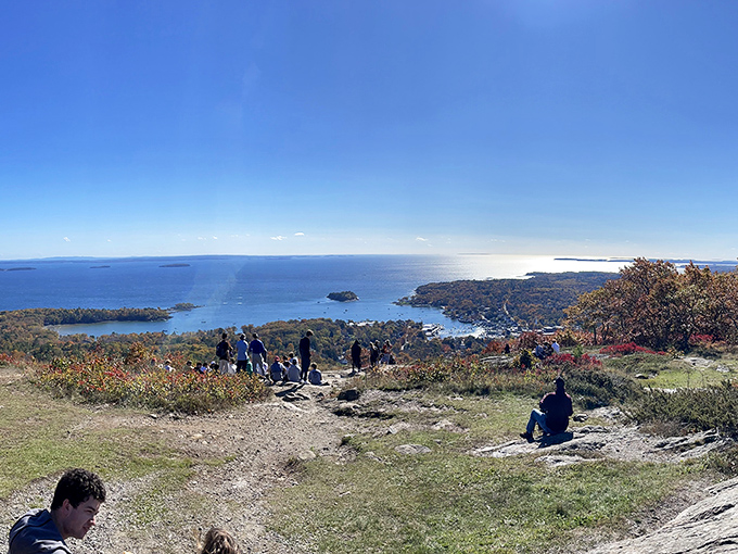 Fellow travelers gather at the summit, strangers united by shared expressions of awe and the universal language of "Wow!"