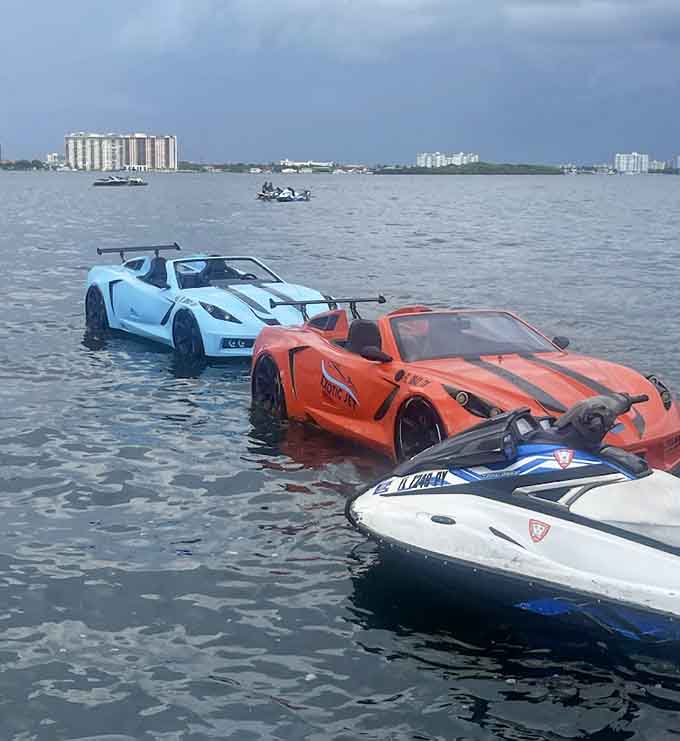 Multiple watercraft gather like they're at a very exclusive car show, except the parking lot is liquid and everyone's wearing sunscreen instead of suits.