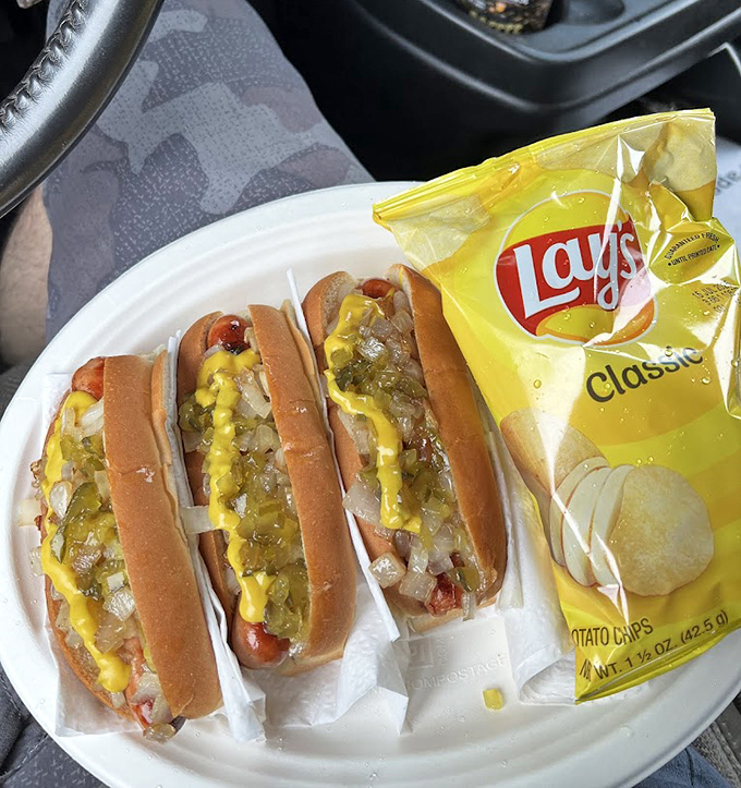 Three perfectly grilled dogs with the works &ndash; a testament to consistency and craft that keeps customers coming back decade after decade.