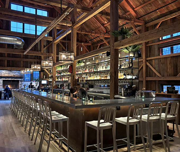 The bar area marries rustic charm with modern sophistication, offering a front-row seat to watch skilled bartenders craft drinks worthy of the historic setting.