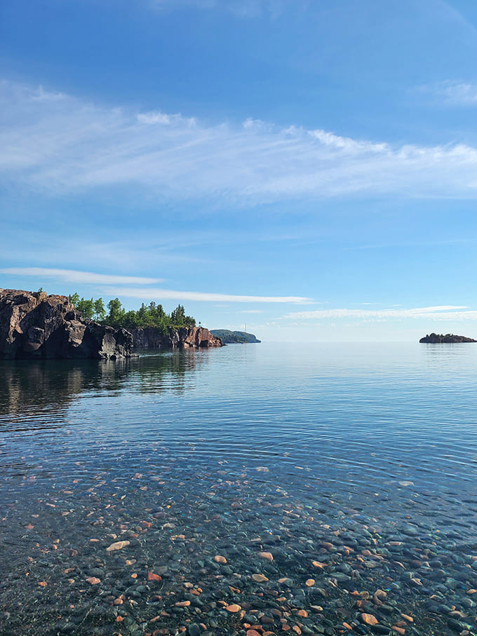 The crystal-clear water reveals the rocky bottom, reminding you that Lake Superior's clarity is legendary for good reason.