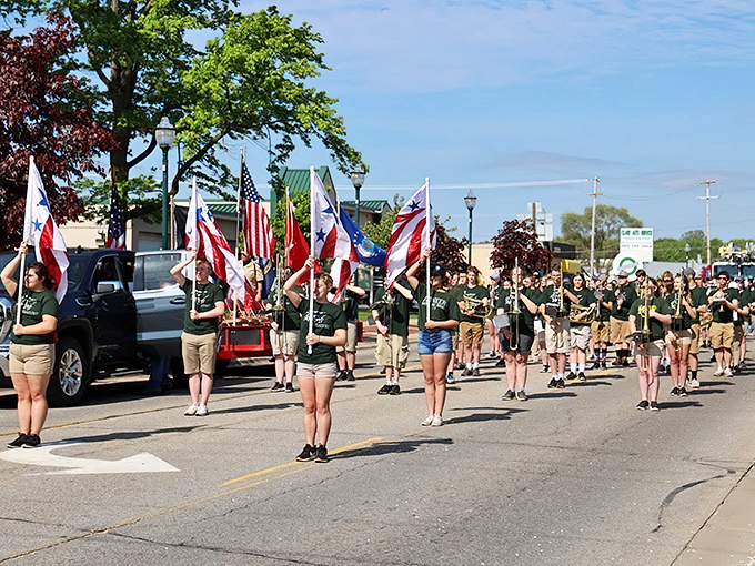 A community parade marches through Clare, with young flag bearers proudly displaying their patriotism during one of the town's beloved local celebrations.