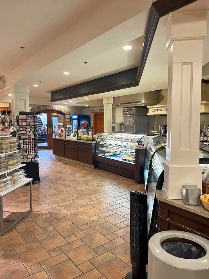 Sweet temptations await behind glass at the bakery counter, where traditional German pastries beckon with buttery, sugary promises.