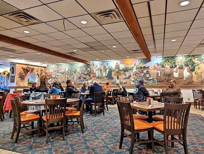 The dining room buzzes with energy as patrons gather beneath colorful murals depicting scenes from Mexican history – a feast for the eyes and palate.