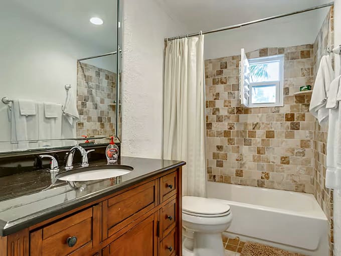 The hall bathroom keeps things simple and stylish with mosaic tiles that add character without overwhelming the space.