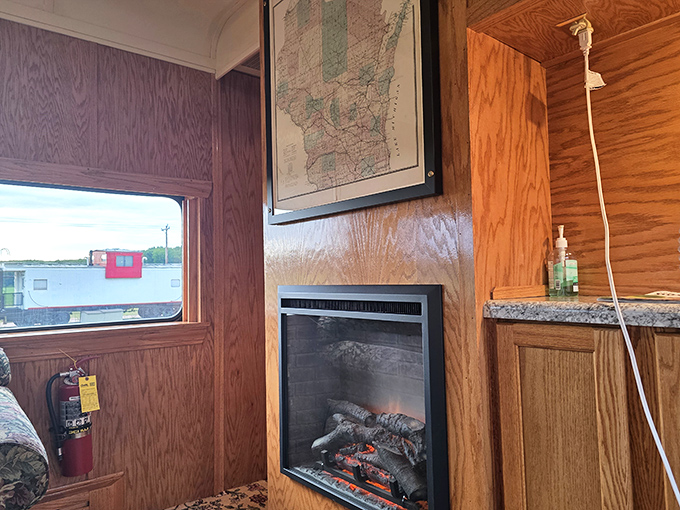 Vintage charm meets modern comfort with an electric fireplace warming this railcar accommodation &ndash; no coal shoveling required!