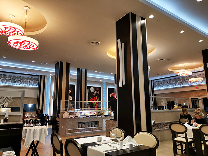 Modern elegance meets buffet practicality – those black columns aren't just holding up the ceiling, they're creating natural pathways to your next culinary discovery.