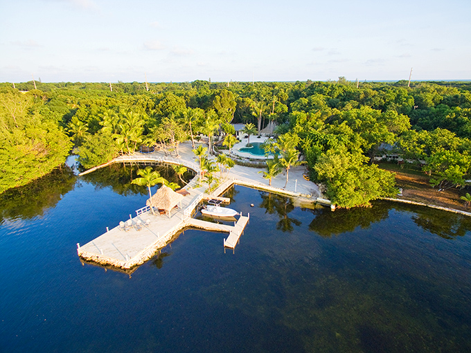 An aerial view reveals the perfect harmony of land and sea, where docks extend like fingers reaching into the welcoming waters.