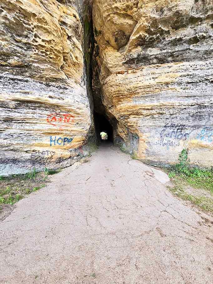 Graffiti meets geology at the rock shelter entrance – even ancient stone can't escape humanity's urge to leave a mark.