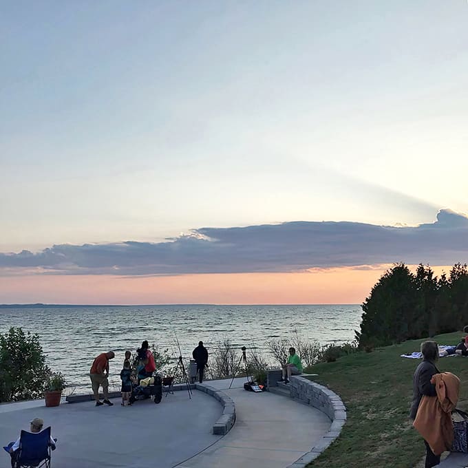 Sunset gatherers assemble at the shoreline amphitheater, a community of wonder-seekers awaiting nature's nightly light show.