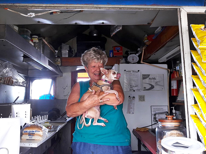 Staff: Behind every great hot dog stand is a dedicated team &ndash; here with a furry assistant who clearly approves of the quality control.