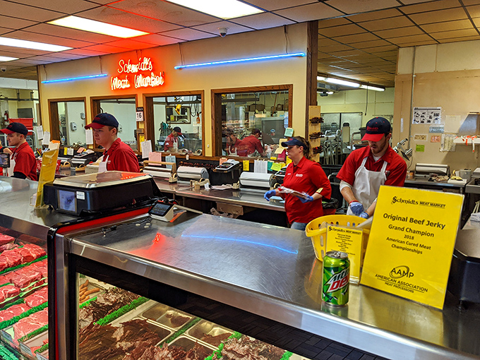 The red-shirted meat maestros work their magic behind the counter, slicing, wrapping, and advising with the confidence of true artisans.