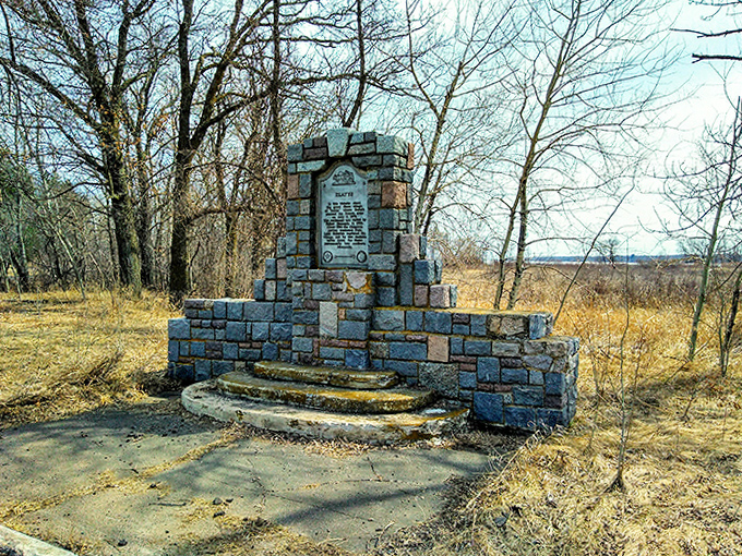 This stone monument stands as a silent storyteller, its weathered face bearing witness to centuries of human passage through these ancient woods.