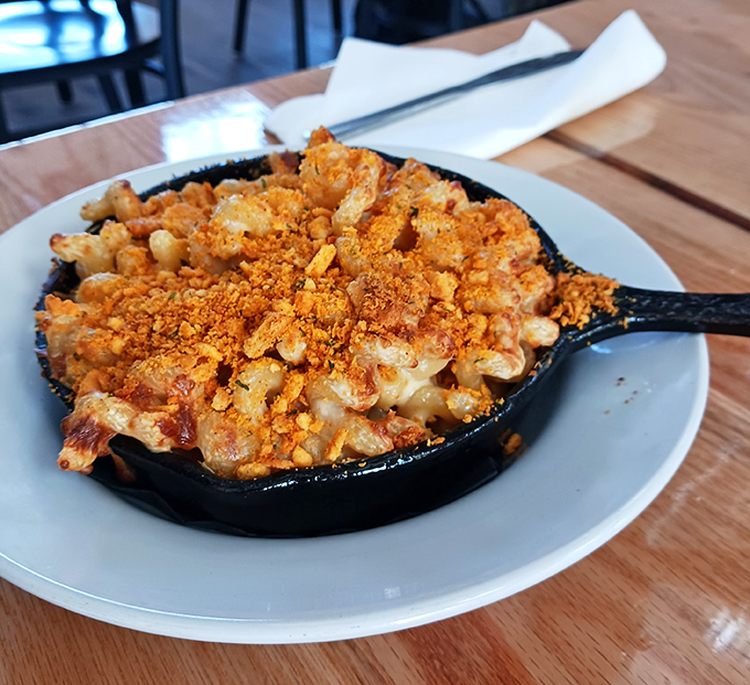 Cast iron skillet mac and cheese bubbling with golden perfection &ndash; each spoonful promising that satisfying cheese pull that makes life worth living.