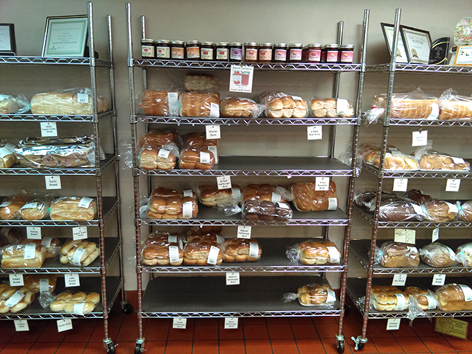 Bread racks filled with wrapped loaves, each one representing hours of proofing, kneading, and baking to perfection.