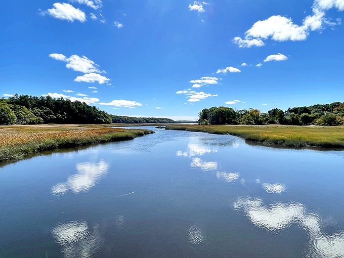 Tranquil wetlands mirror perfect cloud formations, creating a double dose of Maine's spectacular sky show.