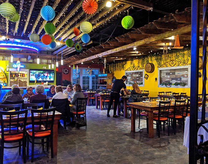 The dining room buzzes with energy as patrons enjoy authentic Mexican cuisine under festive decorations that keep the fiesta going year-round.