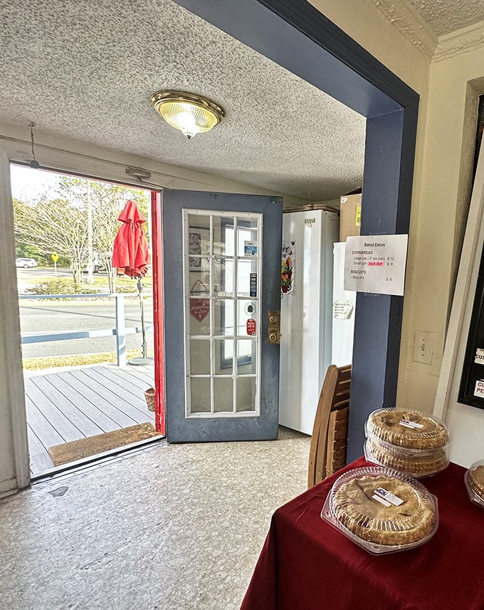 The exit view reveals outdoor seating perfect for contemplating life's mysteries while eating pie in the sunshine.