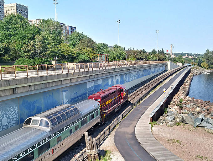 The boardwalk traces Lake Superior's edge, offering pedestrians and train passengers alike front-row seats to nature's grandest stage.