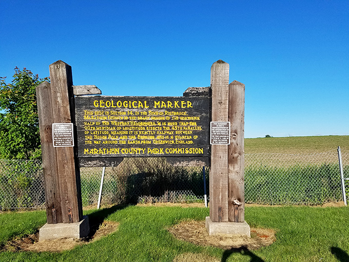 The original geological marker stands weathered but proud, like a grandfather telling the same great story for decades.
