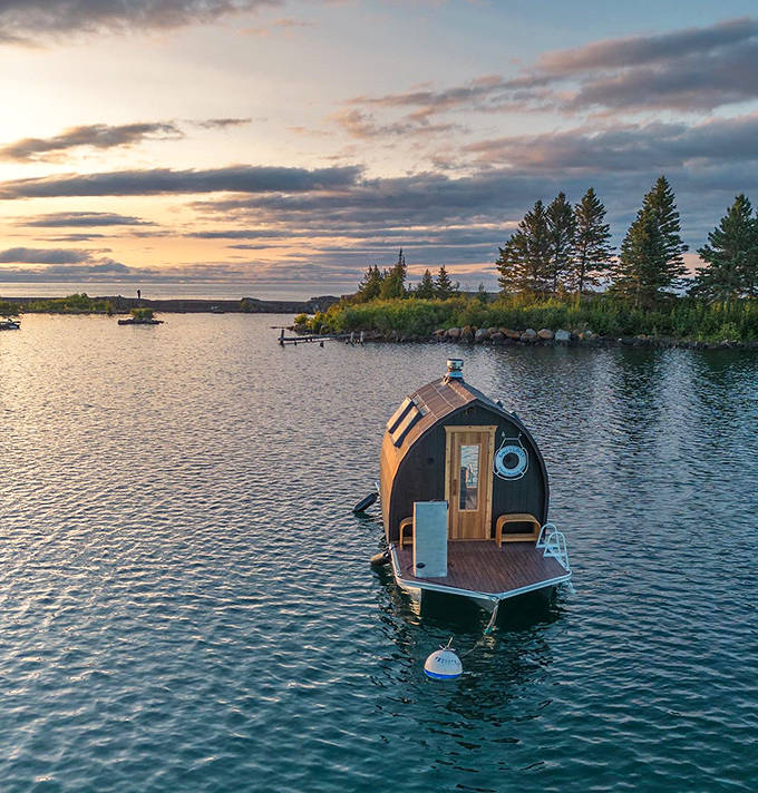 Viewed from above, the floating sauna resembles a wooden ark adrift on Lake Superior's blue expanse, carrying relaxation instead of animals.