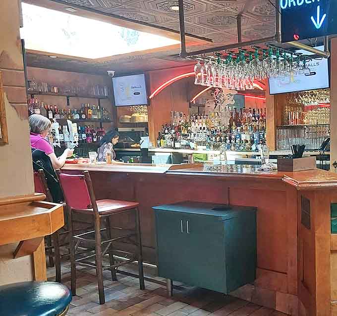 The bar gleams with bottles of premium tequila and mezcal, a liquid library of agave spirits waiting to be transformed into signature cocktails.