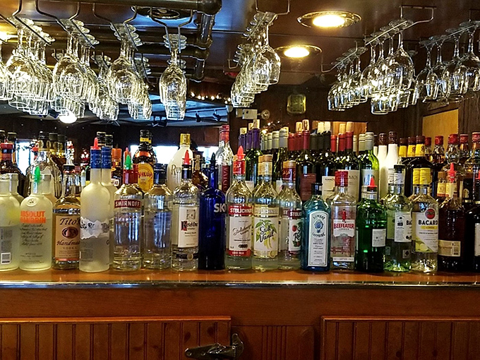 A well-stocked bar with gleaming bottles promises the perfect pairing for whatever delicious decision you've made tonight.