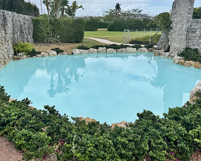 Turquoise waters of the castle's fountain provide striking contrast against the weathered coral structures.
