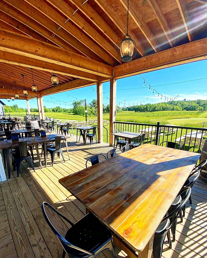 The covered patio offers front-row seats to nature's show, with vineyard views and wooden beams framing the pastoral landscape.